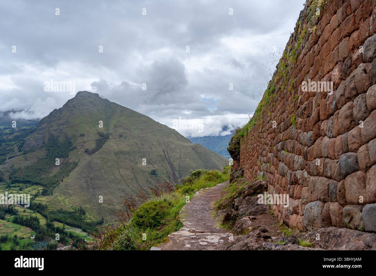The Inca archaeological site of Pisac sits atop a lush green valley ...