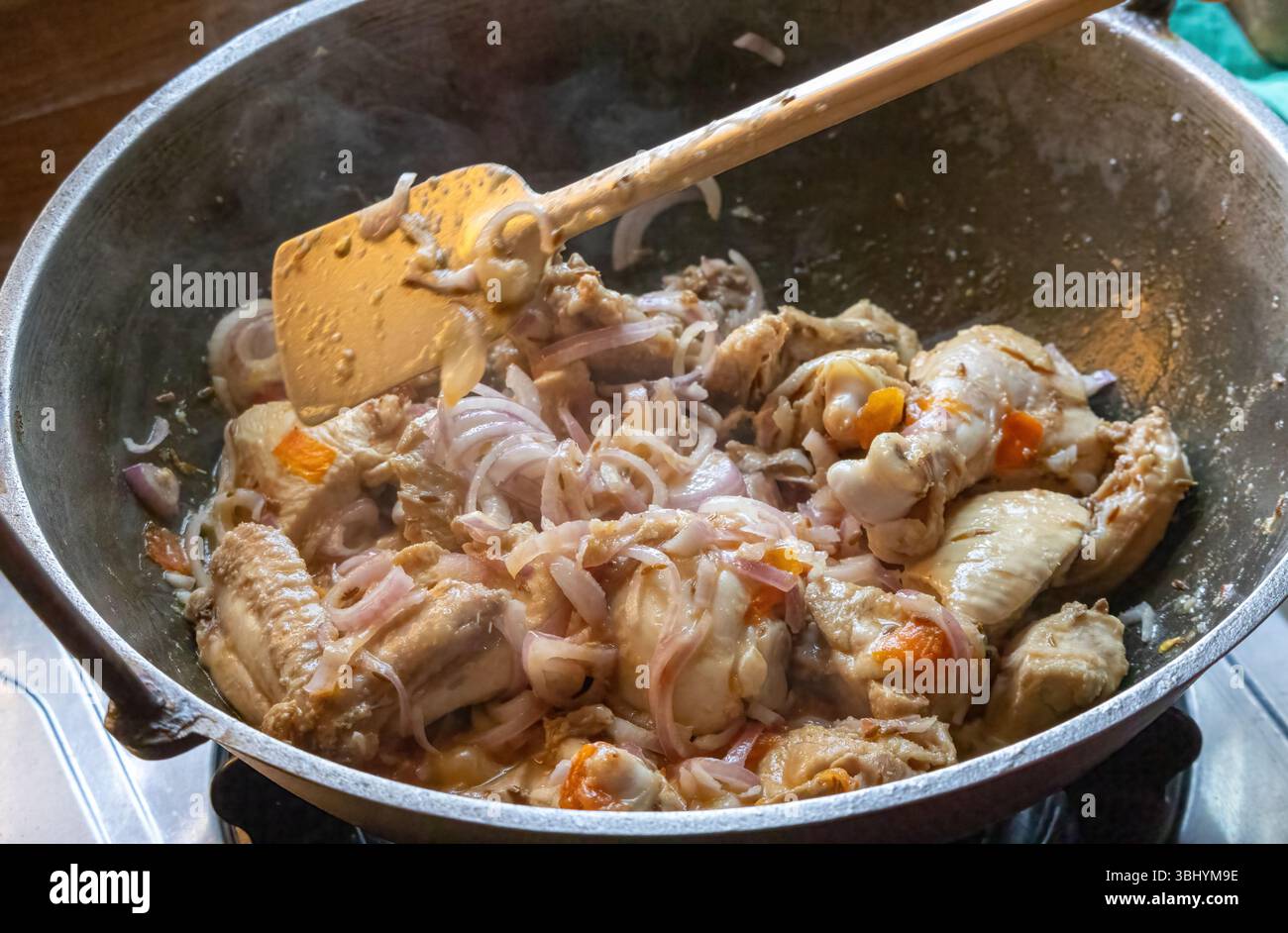 Stirring delicious Irani Chicken Karahi or Kadai Bhuna curry in home ...