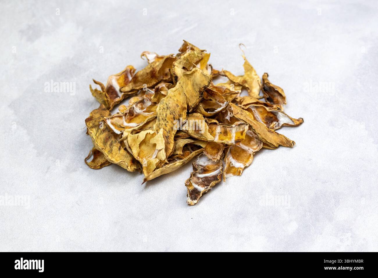 Sun-dried hyacinth bean husks on white. Lablab purpureus. Natural soil ...