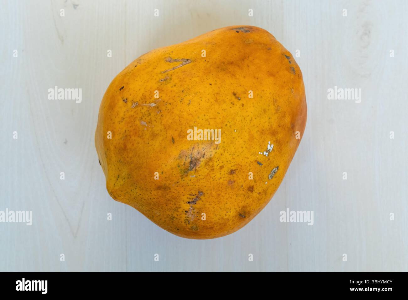 Fresh ripe papaya fruit on light wood, top view. Rich in vitamins A, C ...