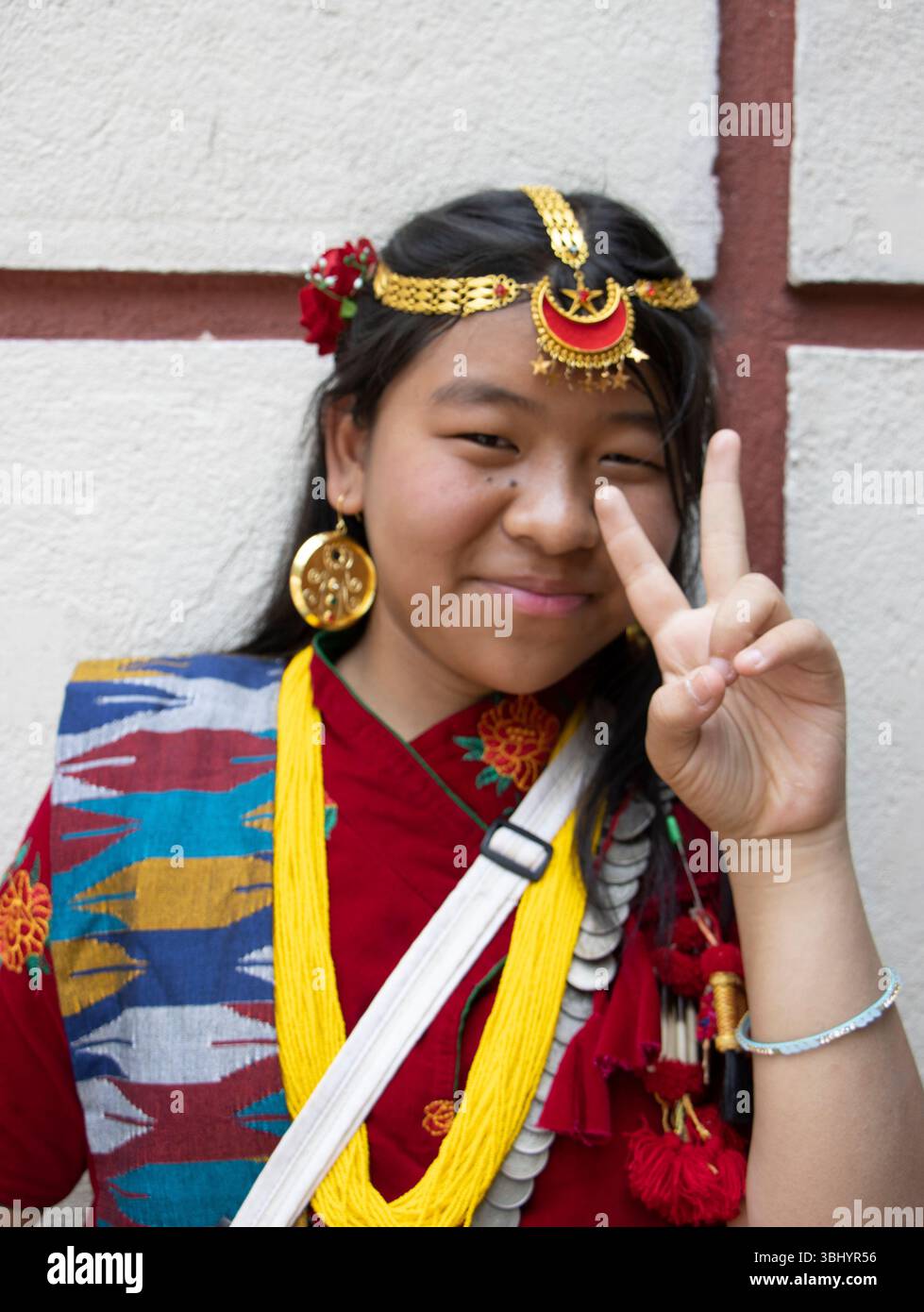 A Kirant youth wears traditional garb and ornaments to attend the ...