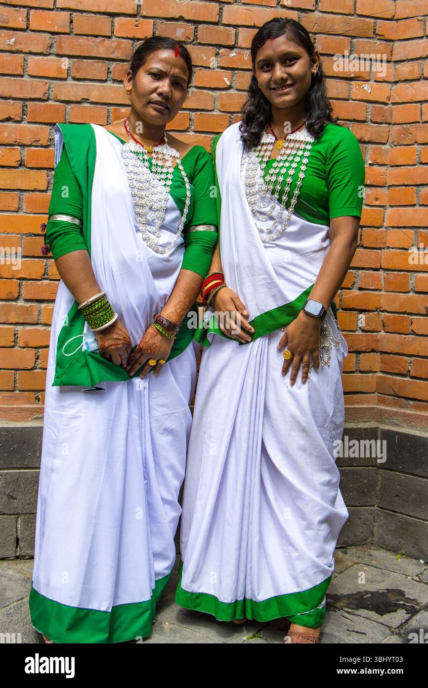 Beautiful Tharu women wear white and green sari (drapes) and arrays of ...