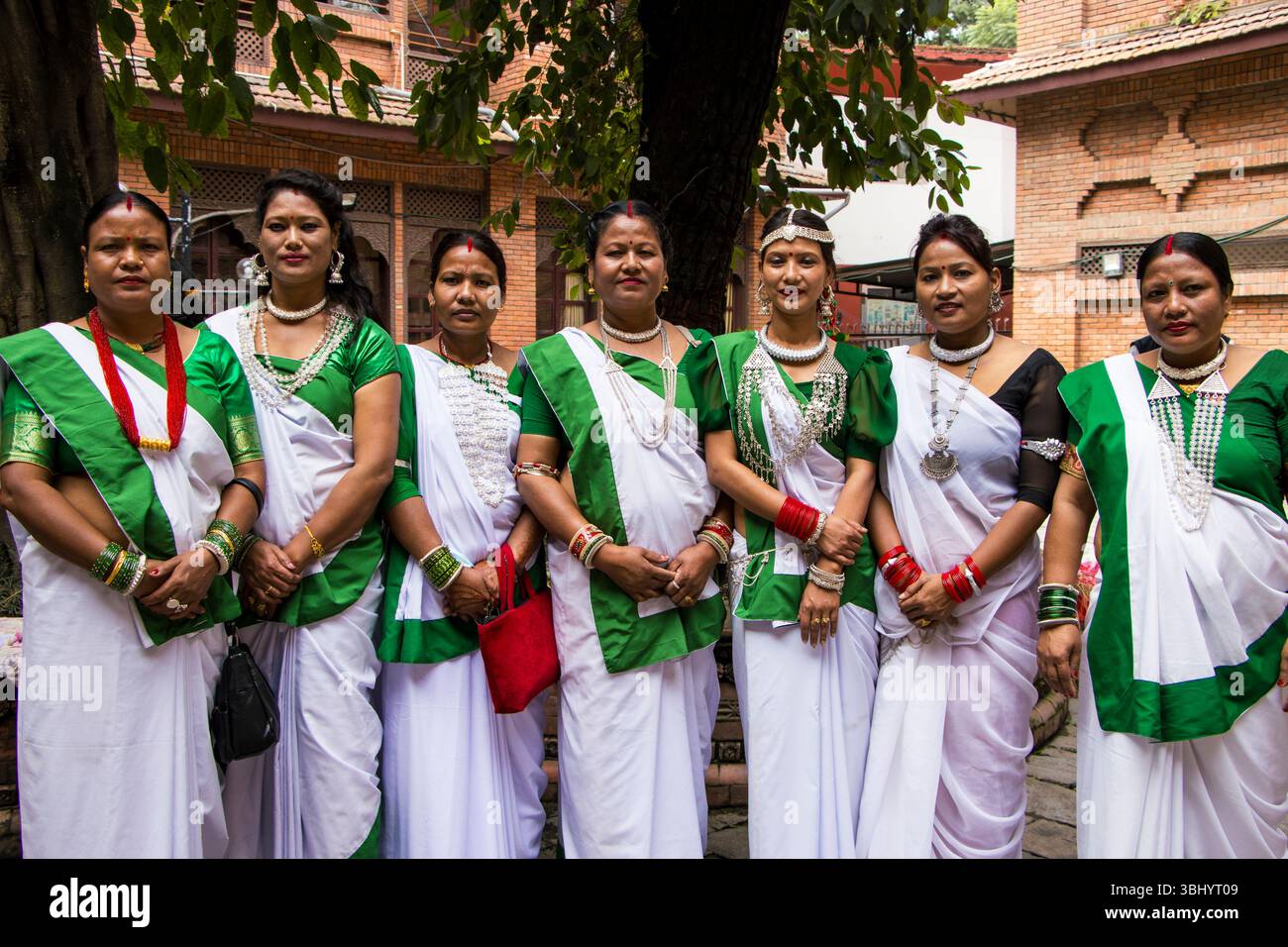 Beautiful Tharu women wear white and green sari (drapes) and arrays of ...