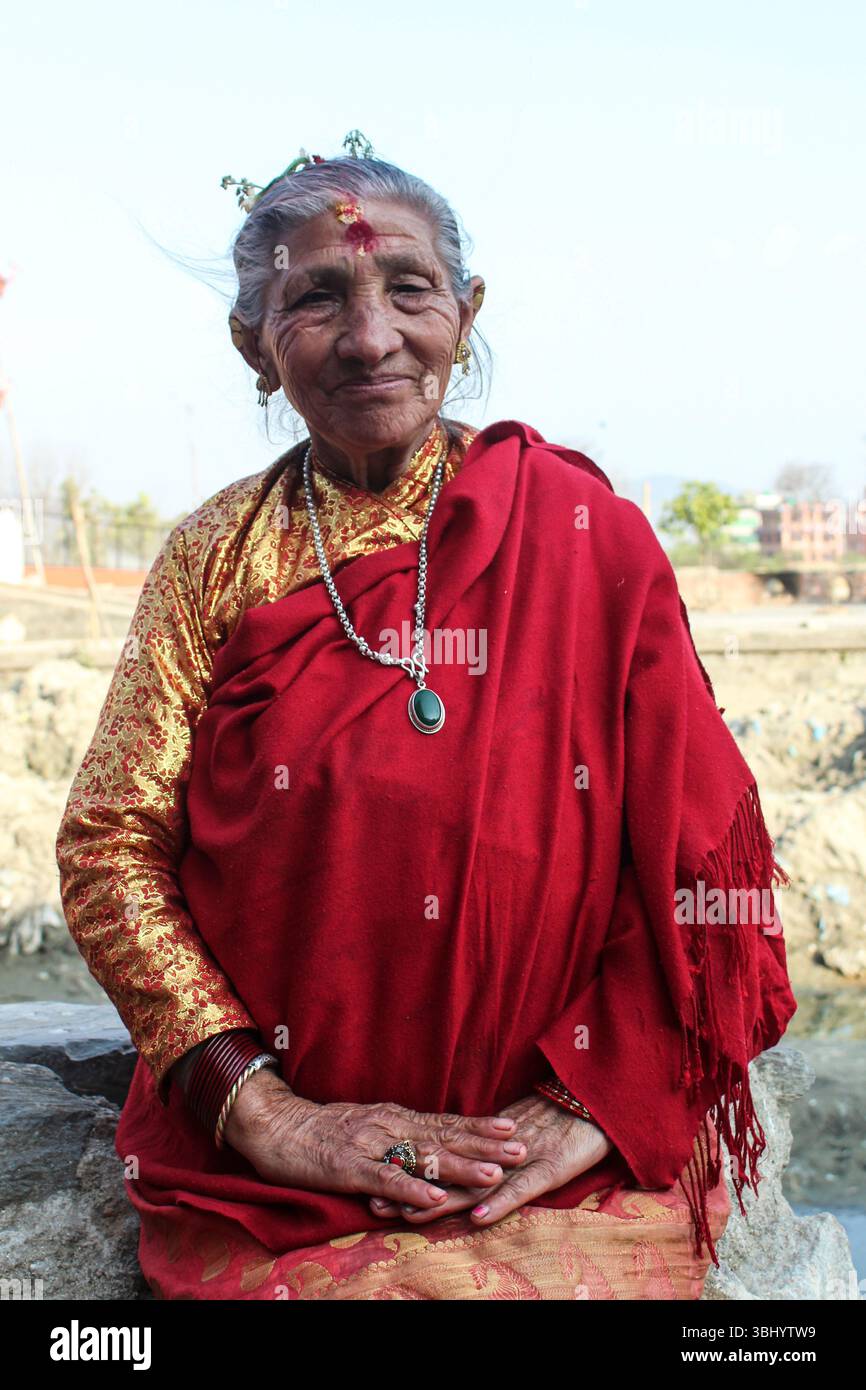 An elderly woman of the Newar caste attends the Madhav Narayan Festival ...