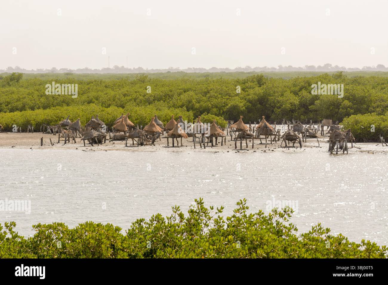 Grain is stored in granaries on stilts at Joal-Fadioth (Joal-Fadiot ...