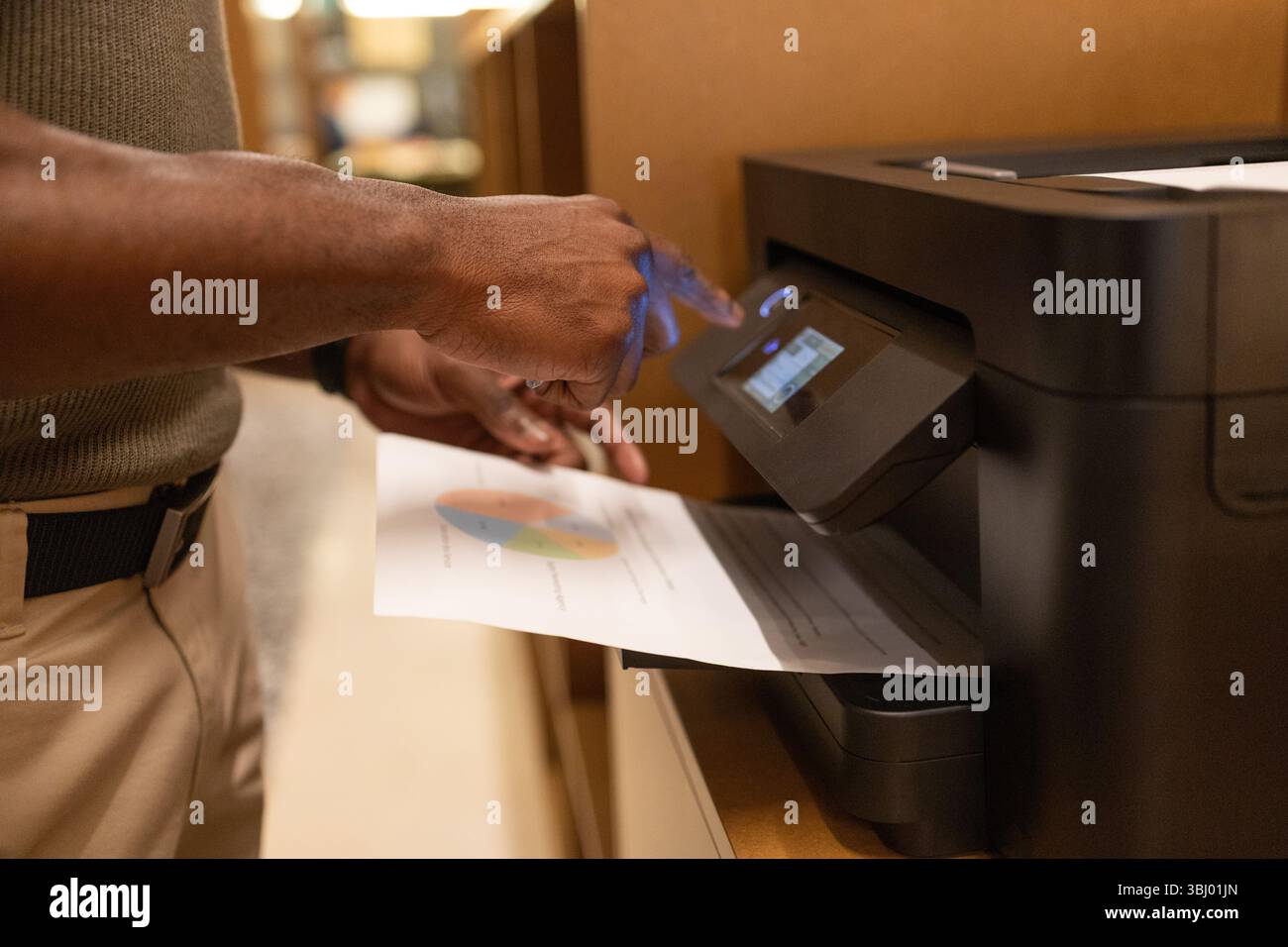 A man operates a printer in a modern coworking space in Barcelona ...