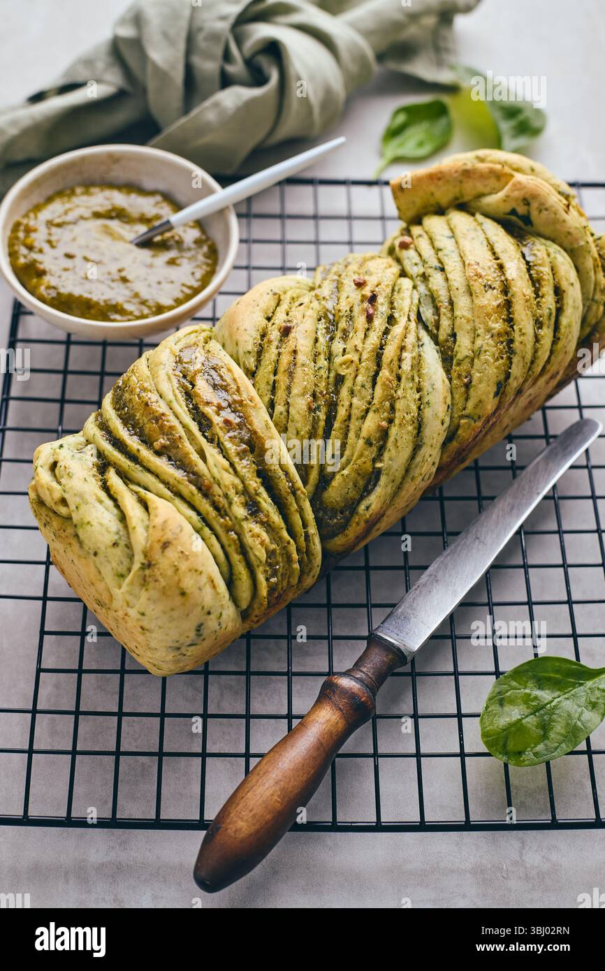 Baked homemade savoury babka plaited bread loaf flavoured with pesto ...