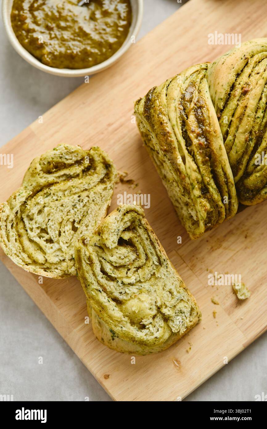 Baked homemade savoury babka plaited bread loaf flavoured with pesto on ...