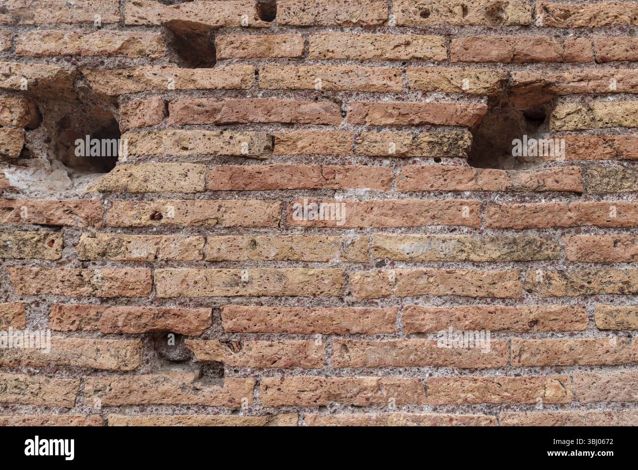 Weathered ancient Roman brick wall revealing aged surface, eroded ...