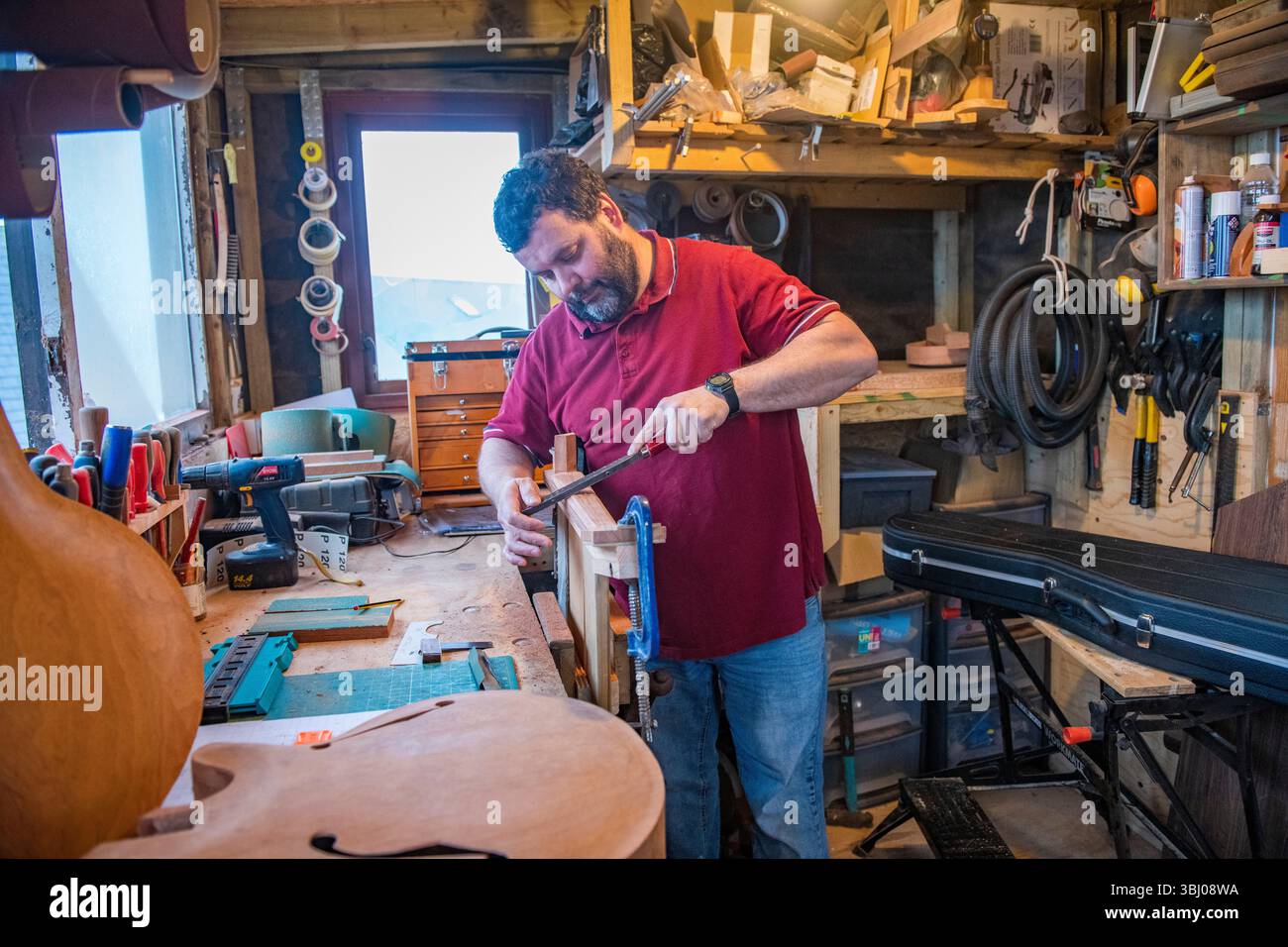 Instrument maker and repairer in Scalloway, Shetland, carefully ...