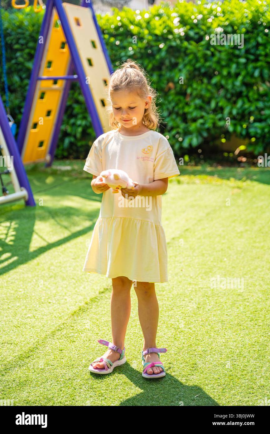 Budva, Montenegro - June 12, 2025: Little girl playing with pink Dada ...