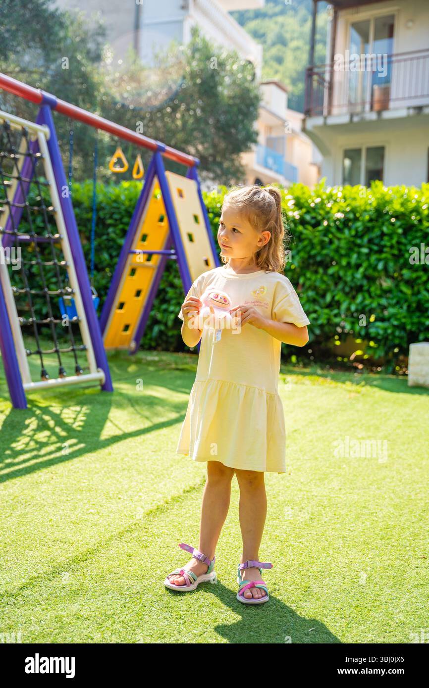 Budva, Montenegro - June 12, 2025: Little girl playing with pink Dada ...