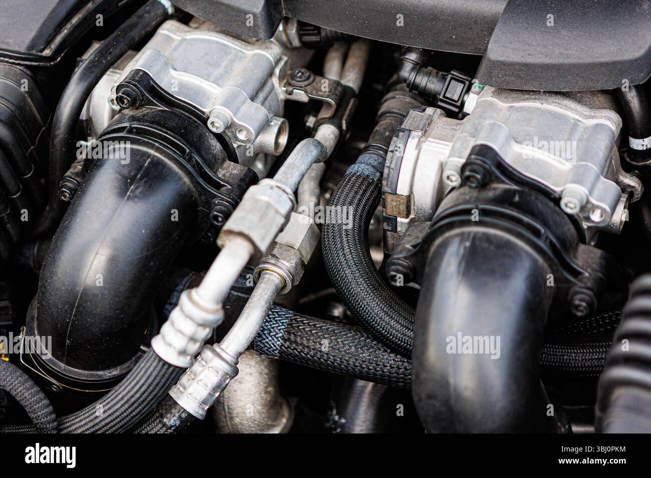 Modern car engine bay, highlighting various mechanical components ...