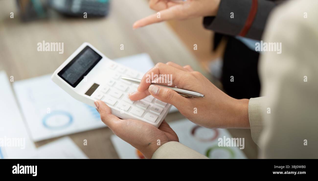Financial Analysis and Calculation. Professionals using calculator for ...