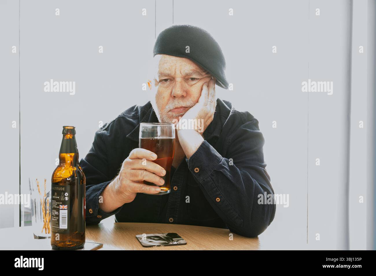 Older man sits table hi-res stock photography and images - Alamy