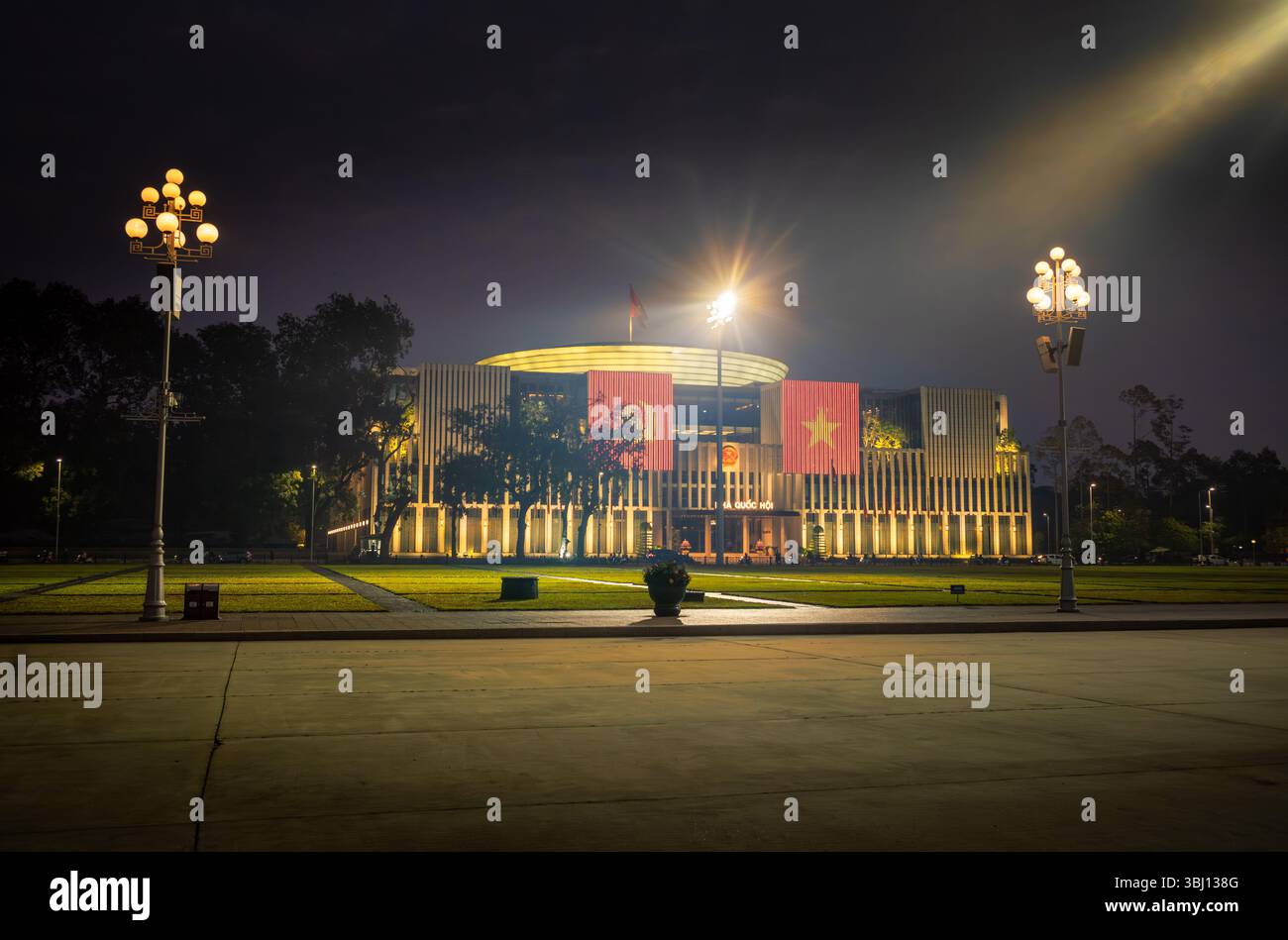 A Vietnam flag and hammer and sickle illuminated on the front of the ...