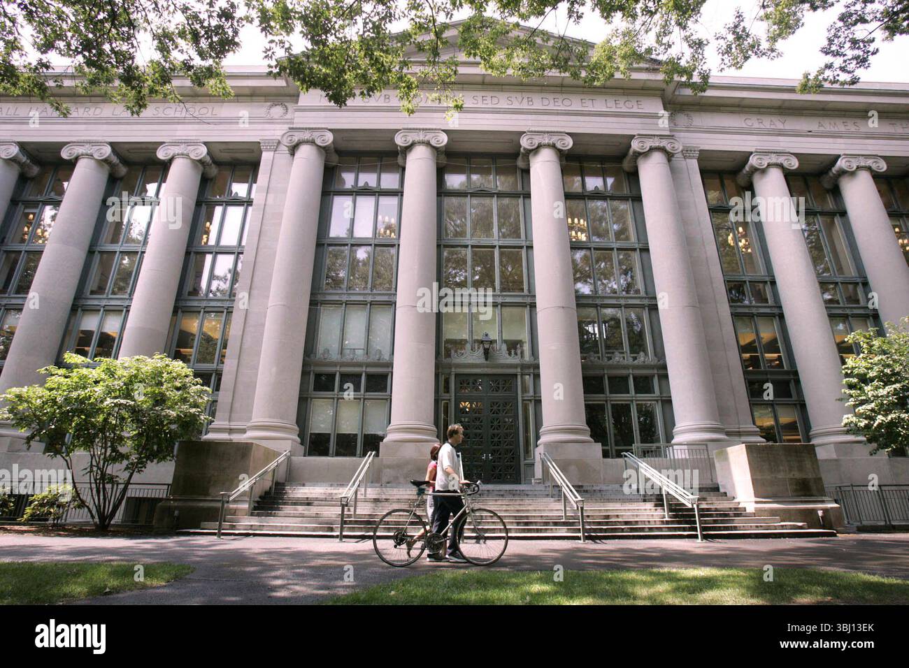 FILE - A bicyclist walks by Langdell Hall, the Harvard Law Library, on ...