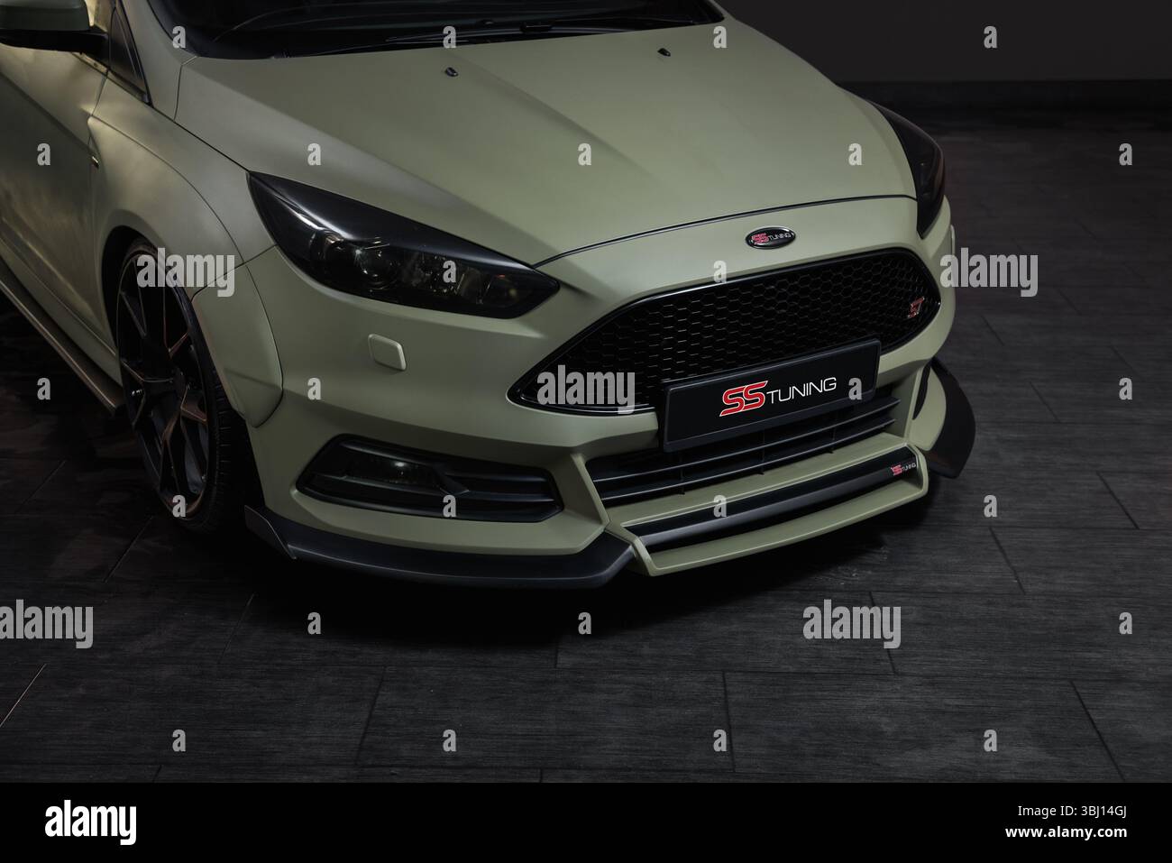 Olive Focus ST in dark garage. Front end view of satin green Ford ...