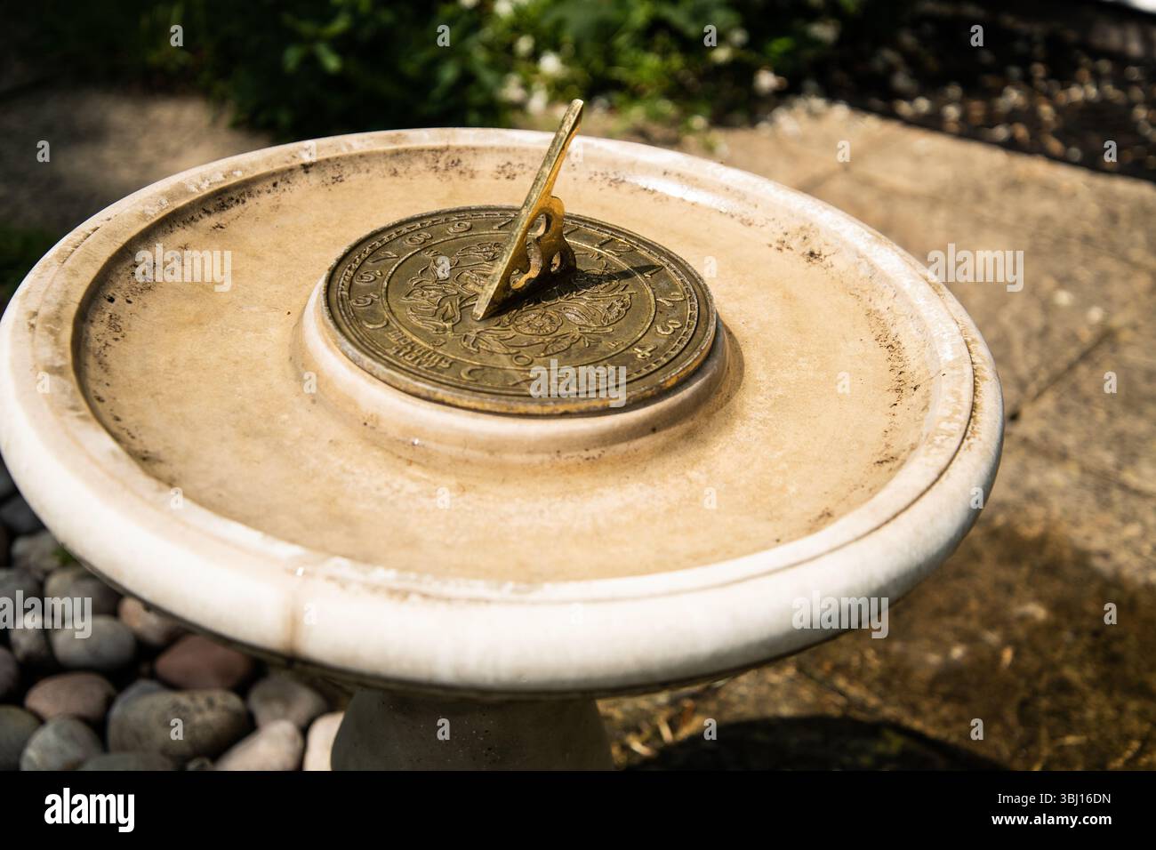 Vintage sundial bird bath showing 1:00 PM, combining timekeeping and ...