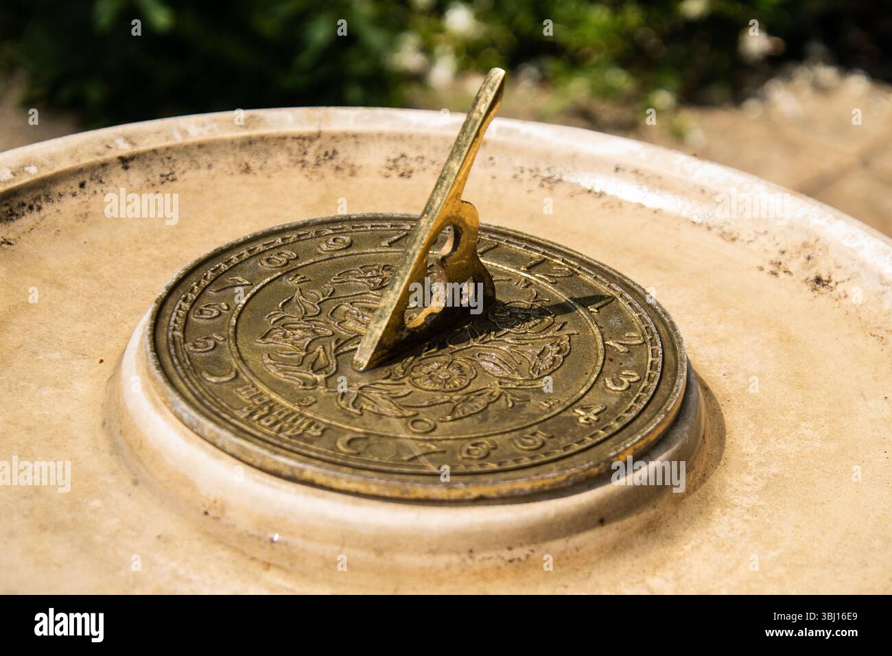 Vintage sundial bird bath showing 1:00 PM, combining timekeeping and ...