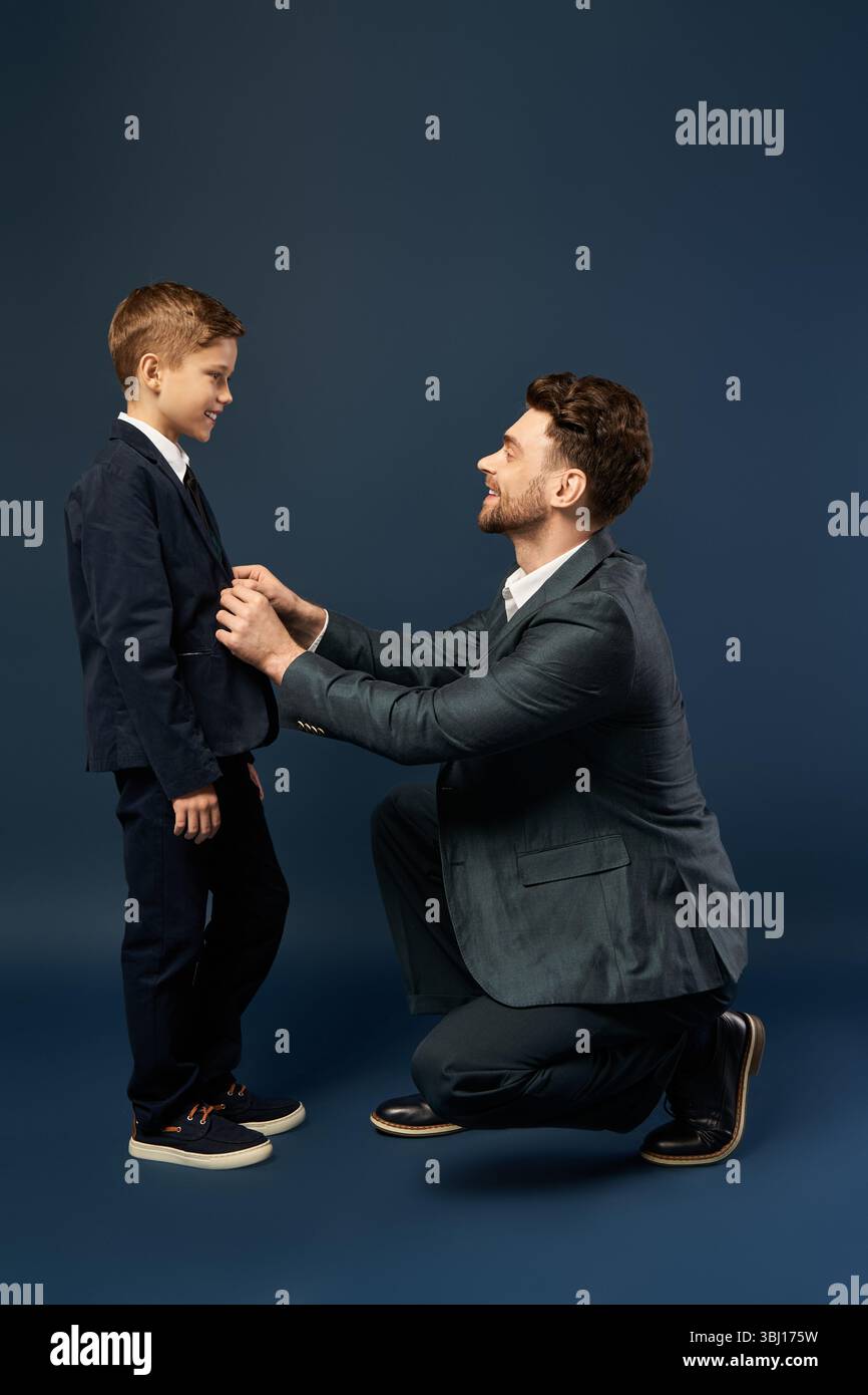 A father lovingly adjusts his sons suit for a special celebration of ...