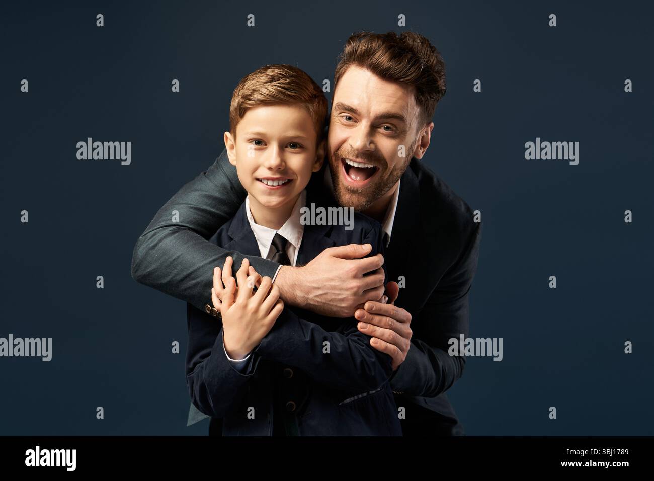 A father and son share a heartwarming moment of joy and celebration ...