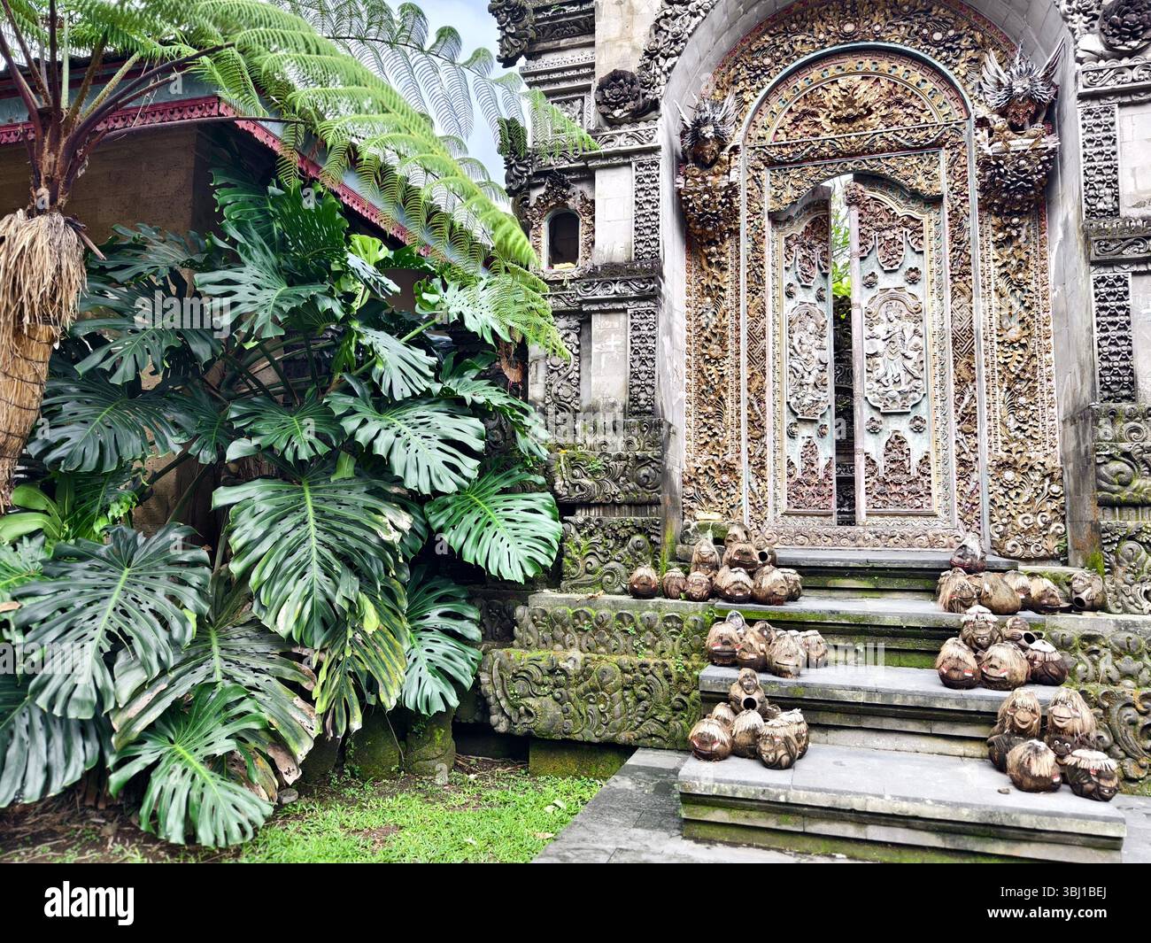 Balinese Temple Entrance with Carved Door flanked by Monkey Coconut ...