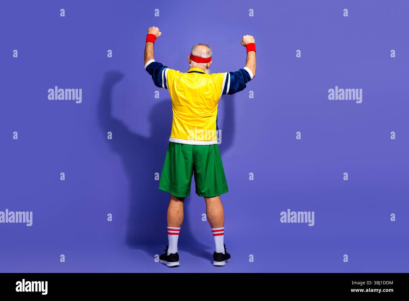 Funny man in retro sports attire celebrates fitness and vitality under ...