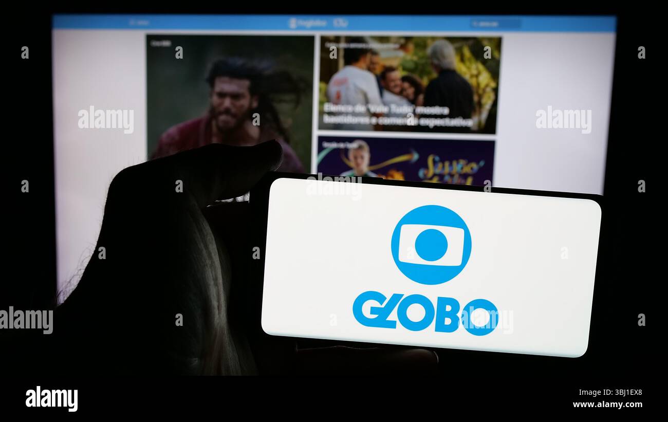 Stuttgart, Germany - 03-27-2025: Person holding mobile phone with logo ...