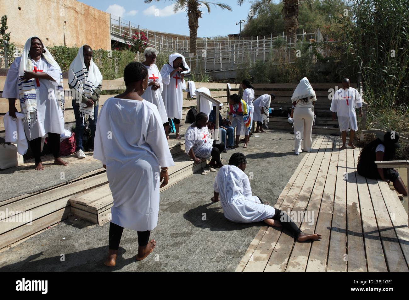 Wet Zambian Christian people rest, meditate & pray on the boards by the ...