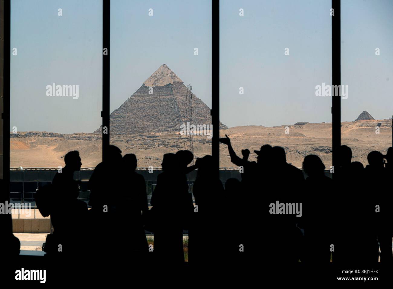 Giza, Egypt. 12th June, 2025. Tourists watch the Pyramid of Khafre ...