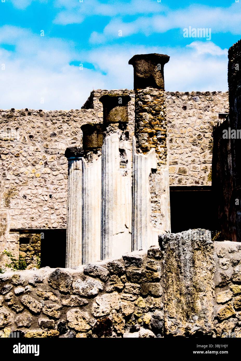 An image of ancient ruins, featuring columns and stone walls under a ...