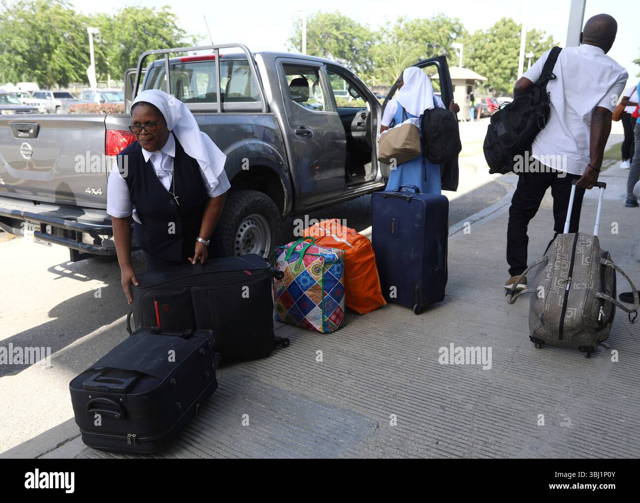Passengers arrive for departing flights at the Guy Malary Airport in ...