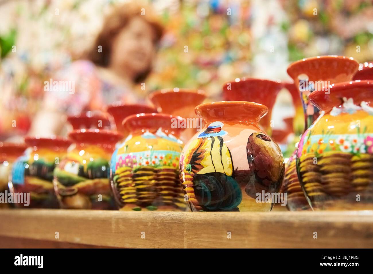Sale of handmade ceramic vases painted with colorful traditional scenes ...