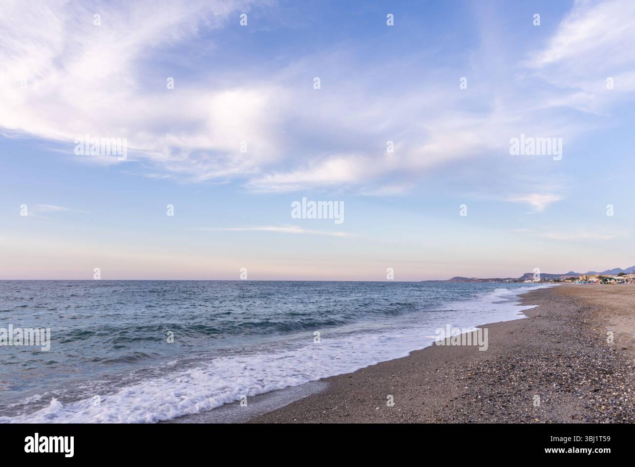 Beautiful coastline with a sandy and pebble beach at sunset. Beautiful ...