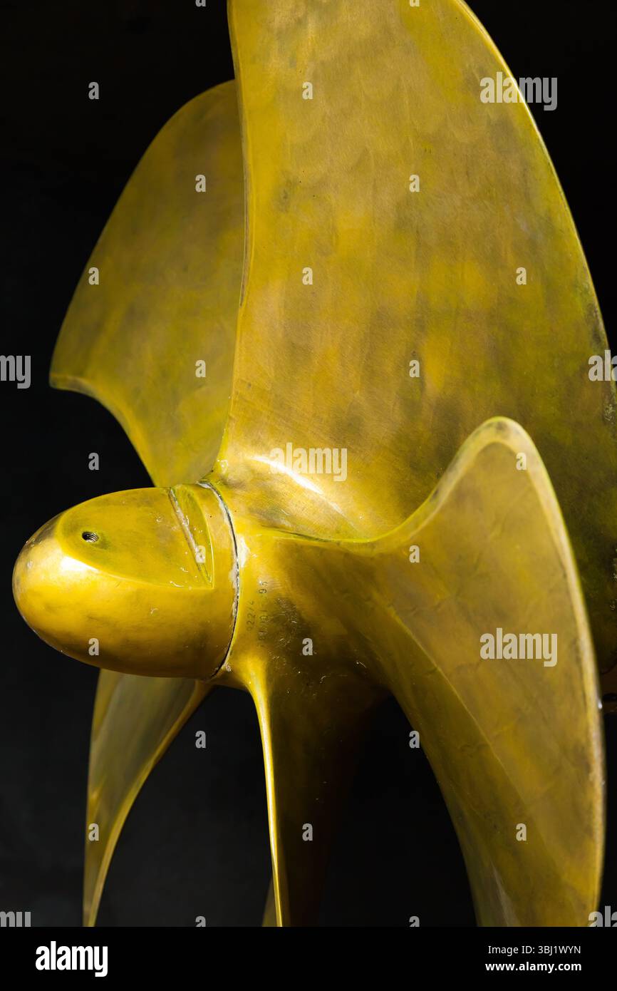 A new bronze five-bladed propeller is installed on the ship, close-up ...