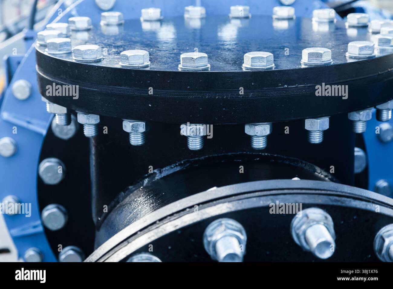 Large pipe connection with a large number of bolts and nuts enclosed on ...