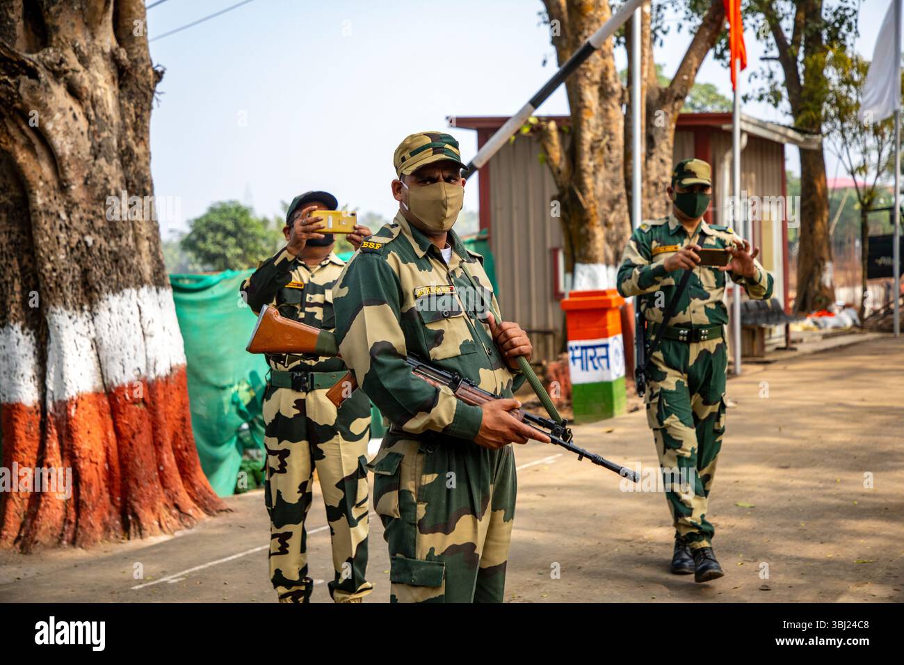 Members of the Border Security Force (BSF) stand guard at the Agartala ...