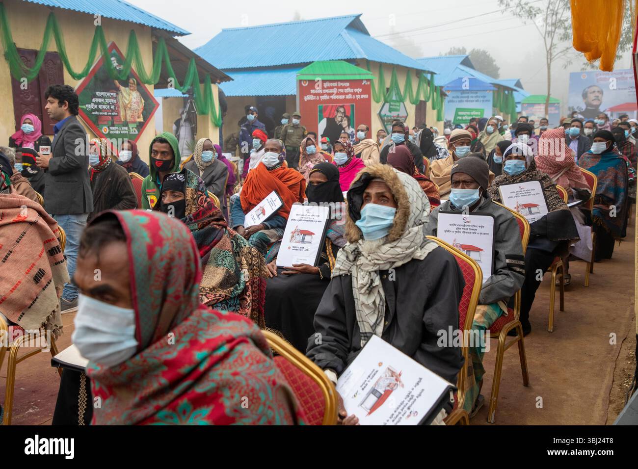 Formerly homeless residents of Habiganj beam with pride as they hold ...