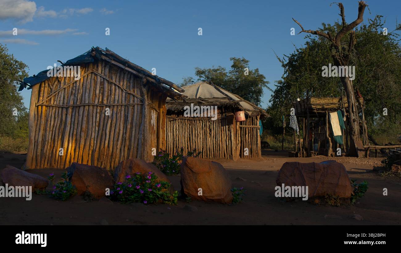 Traditional Wooden Huts in Rural Mozambique with Rocks and Wildflowers ...
