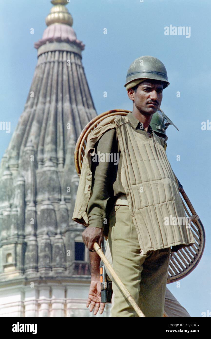 An Indian riot policeman guards a Hindu temple after violent protests ...
