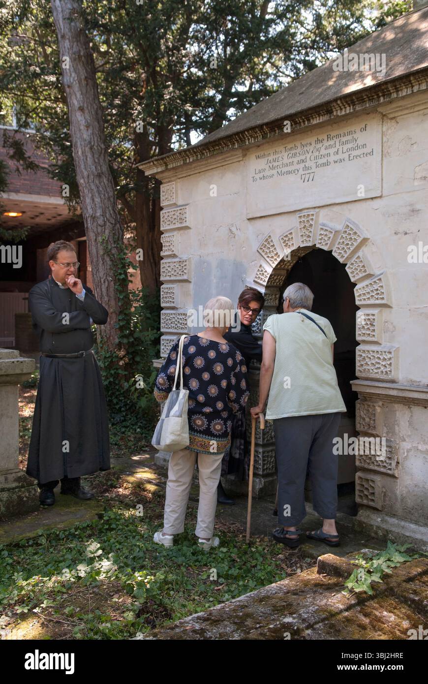 The Gibson family vault door is opened and visitors looking inside ...