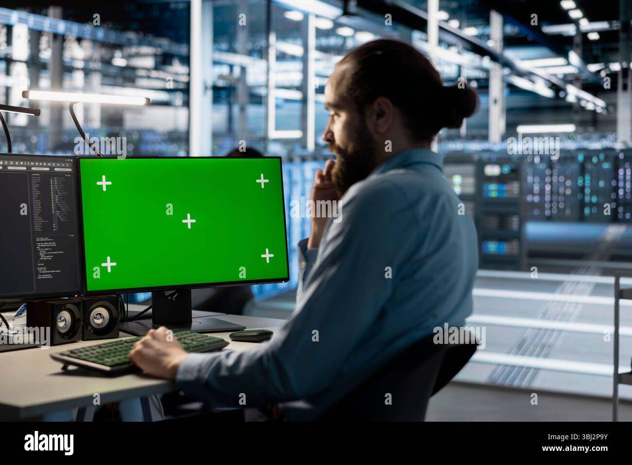 Technician using green screen mockup PC in data center to update servers tech, configuring ...