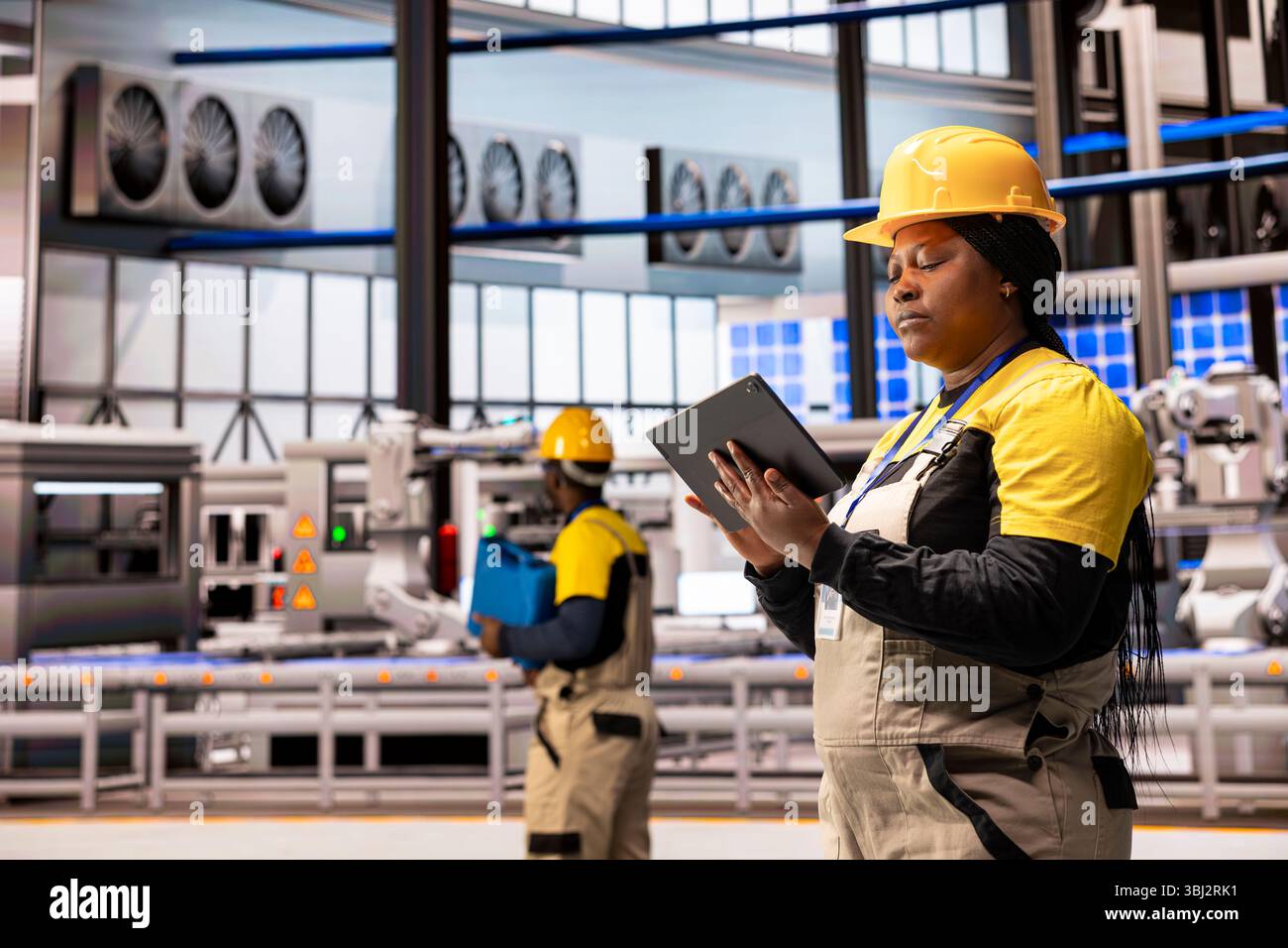Female engineer in smart manufacturing plant monitors production line ...
