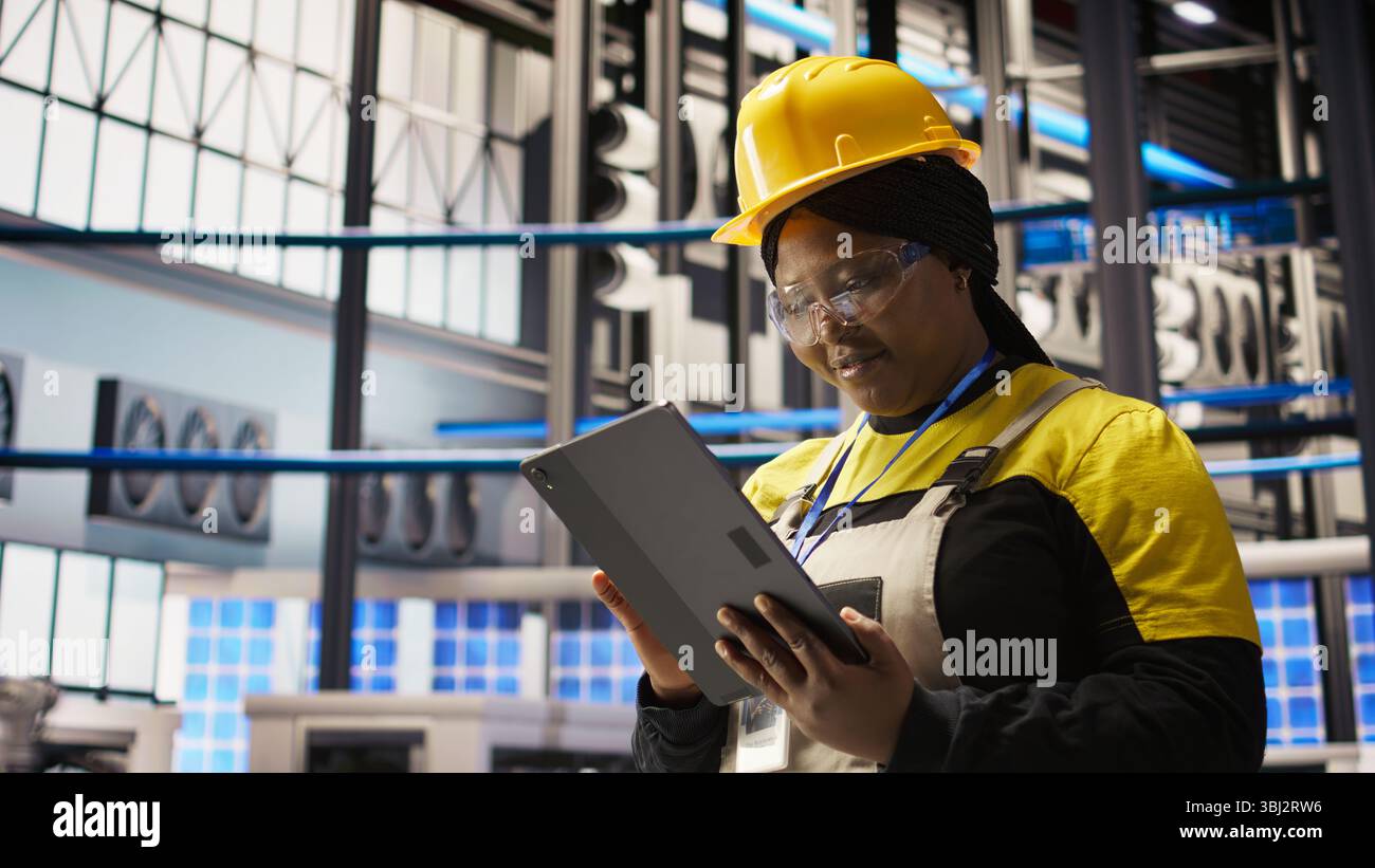 Upbeat professional working in smart factory oversees robot production ...