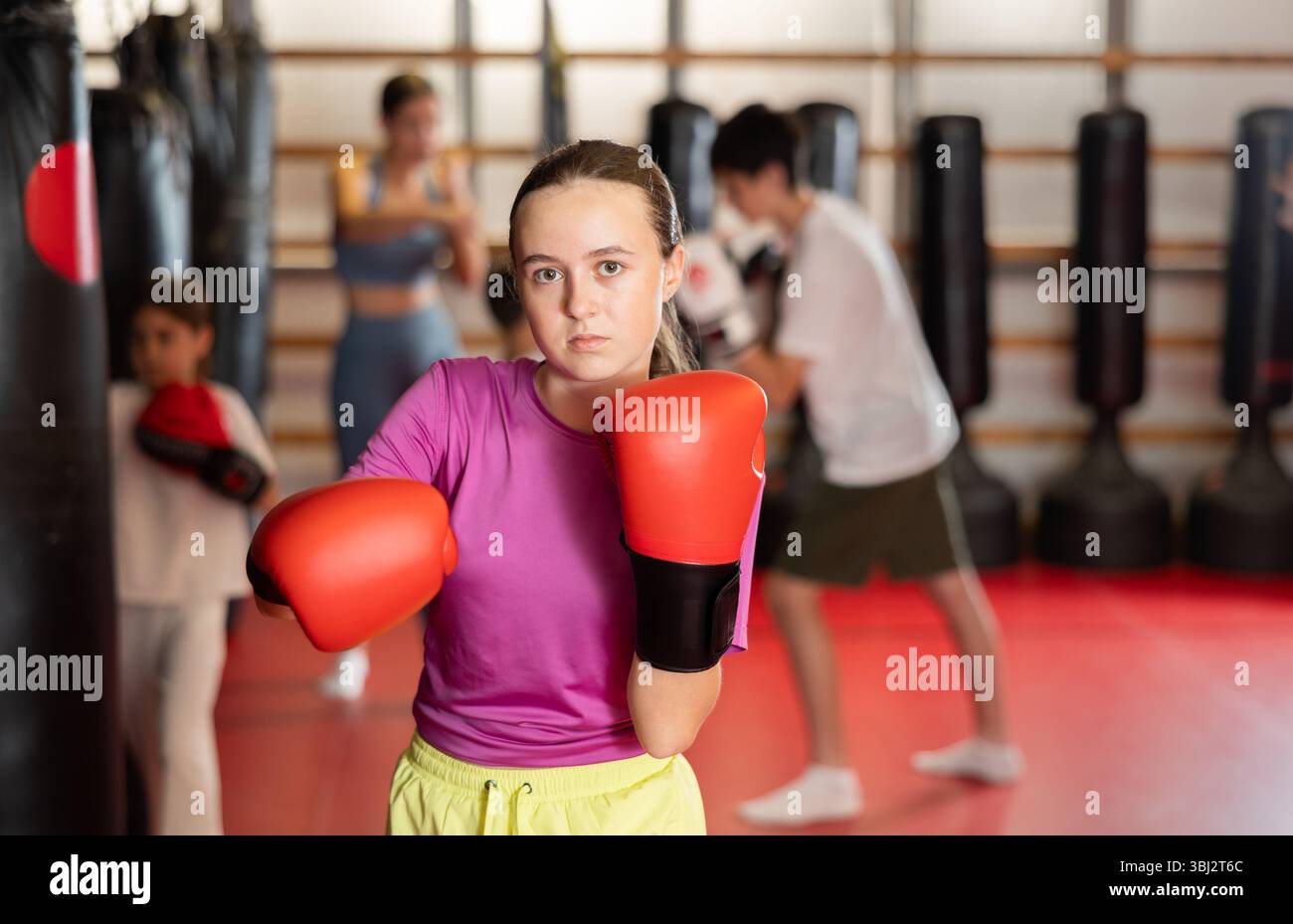 Teen girl in boxing gloves in training Stock Photo - Alamy