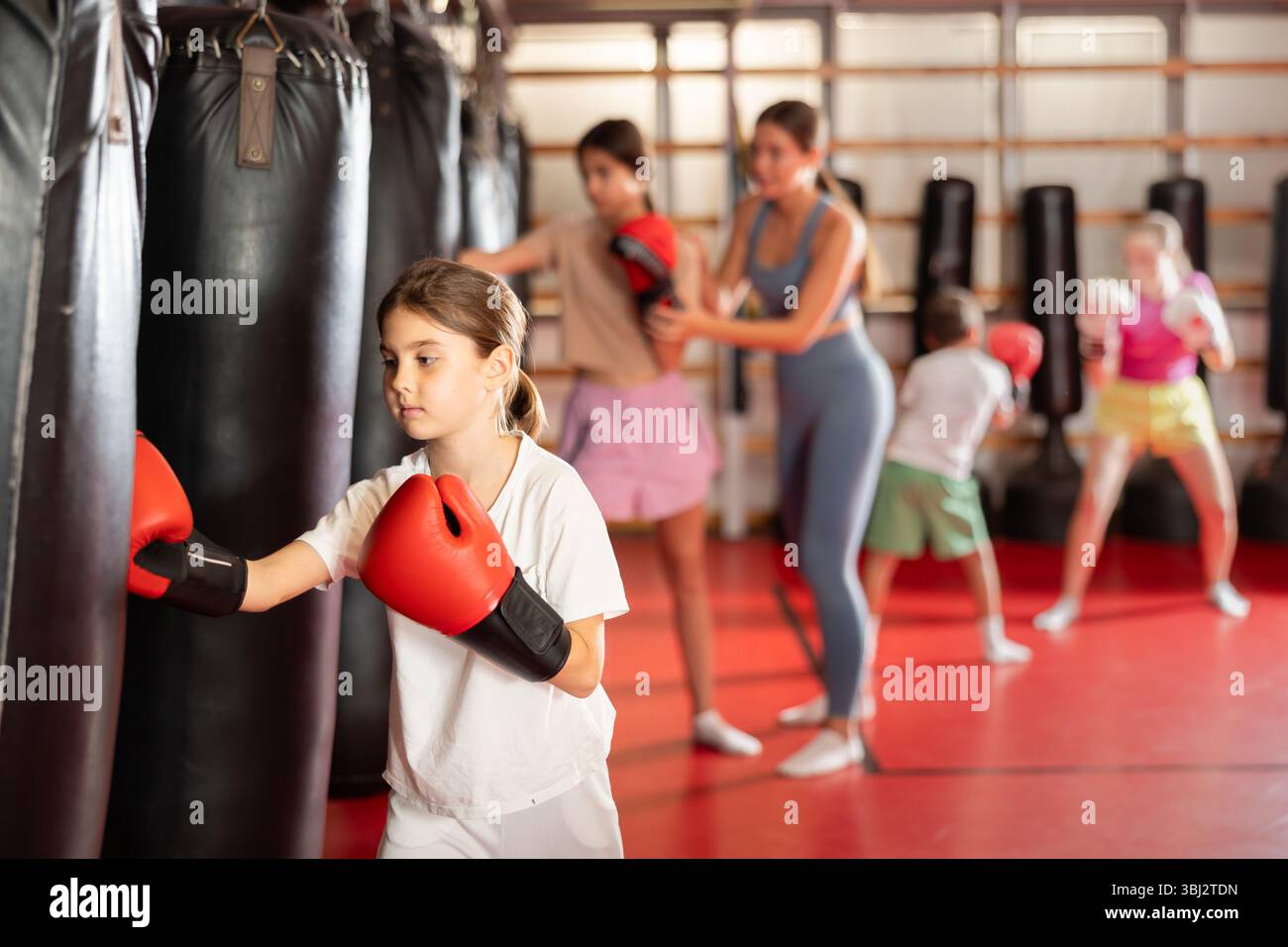 Teen girl in boxing gloves in training Stock Photo - Alamy