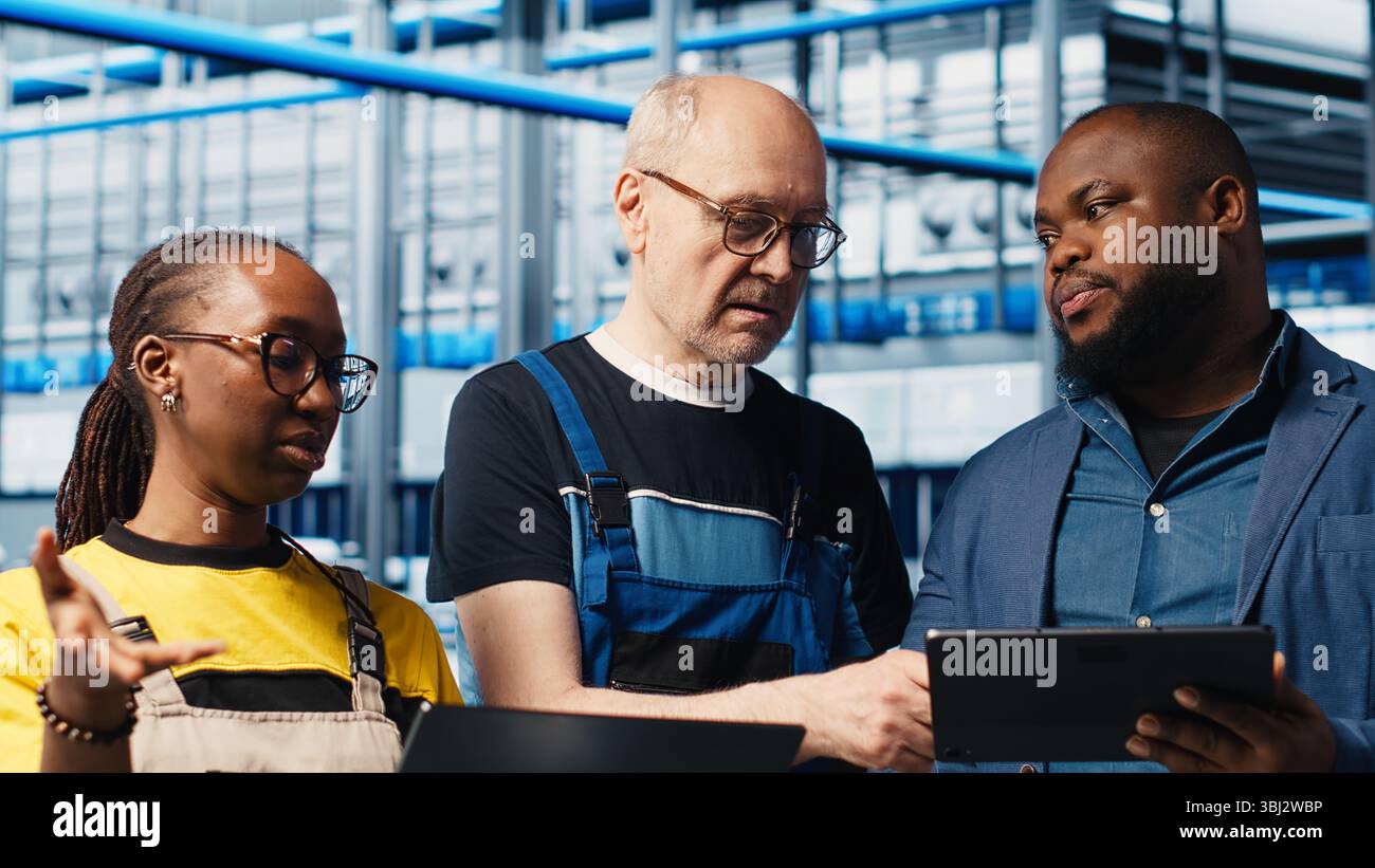 Smart factory team leader and colleagues implement automated workflows ...