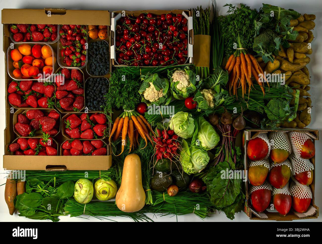 Flat lay still life of assorted fruits, vegetables, and berries ...