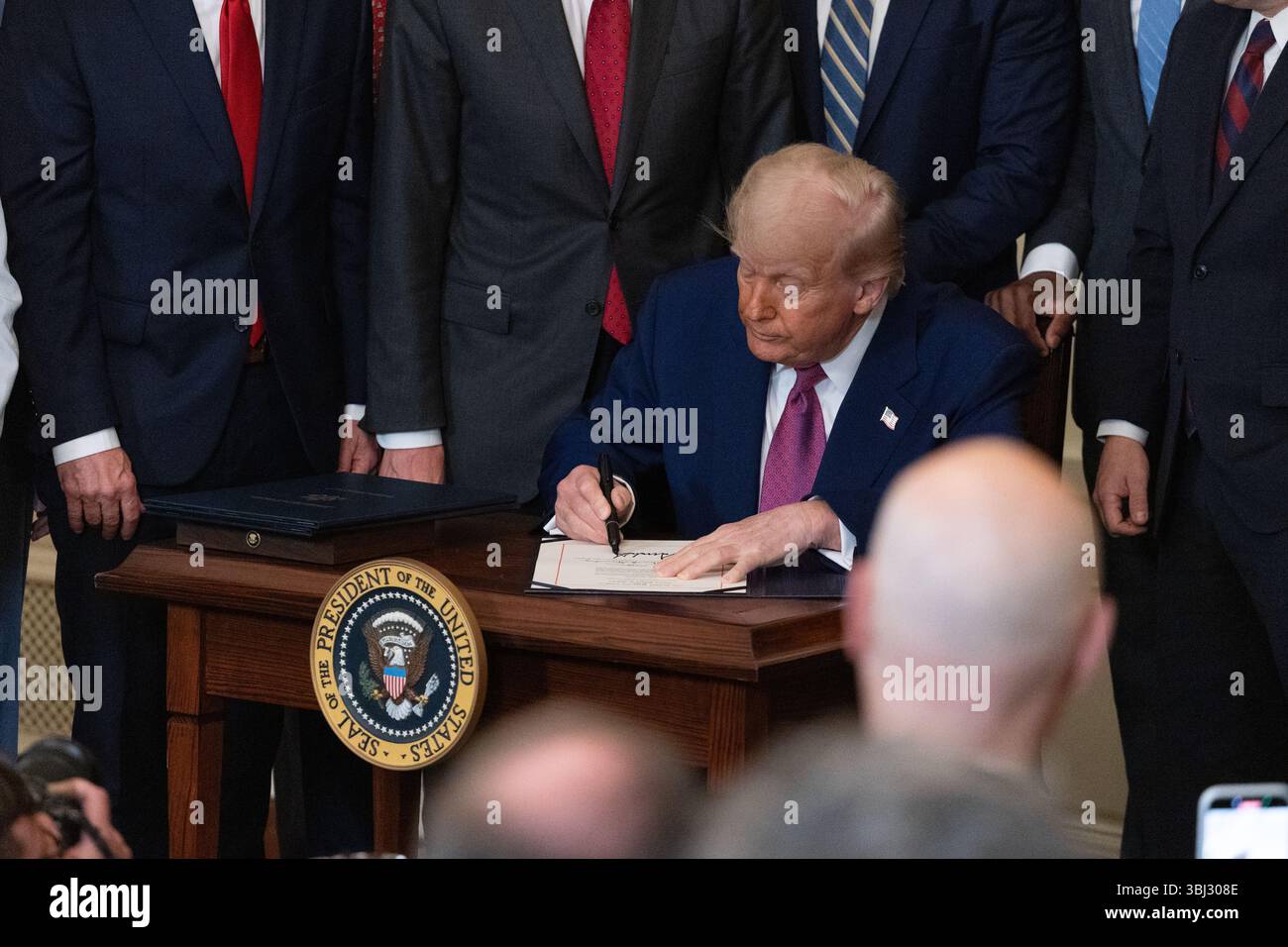Washington, USA. 12th June, 2025. U.S. President Donald Trump signs a ...